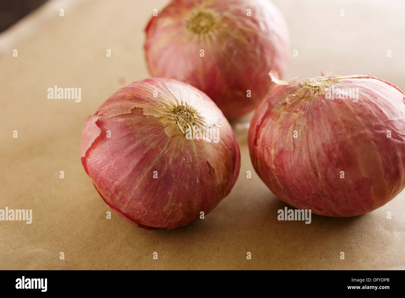 Three Onions on a table Stock Photo - Alamy