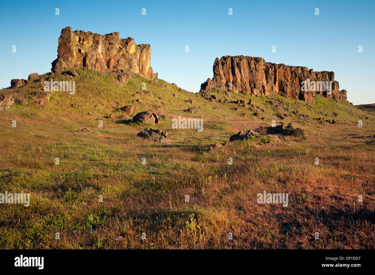 WASHINGTON - Columnar basalt buttes on the grass covered prairie near ...