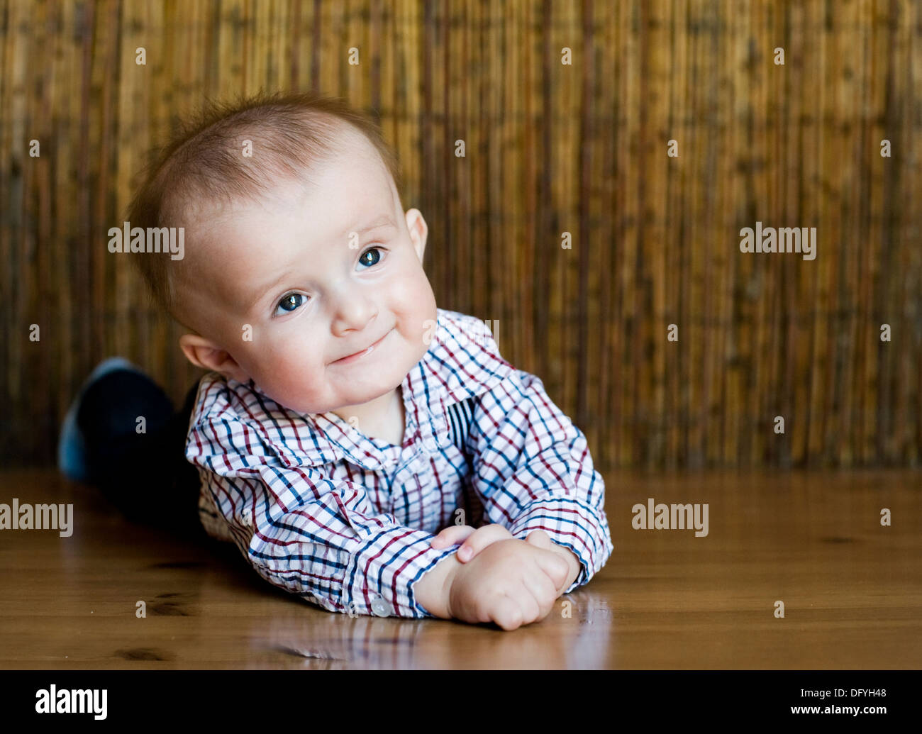 The small cheerful kid lie on a floor Stock Photo - Alamy