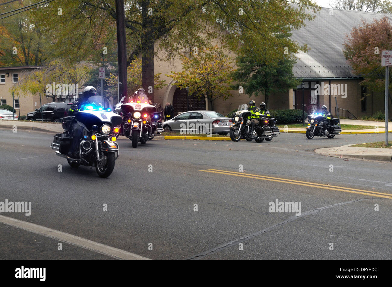 police on motorcycles riding down the street in Greenbelt, Maryland ...
