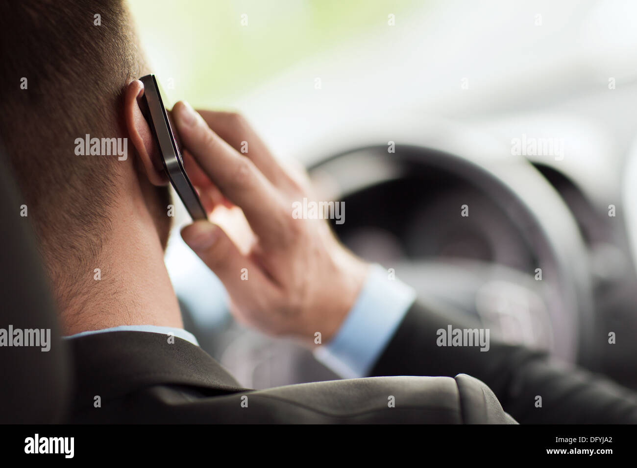 man using phone while driving the car Stock Photo - Alamy