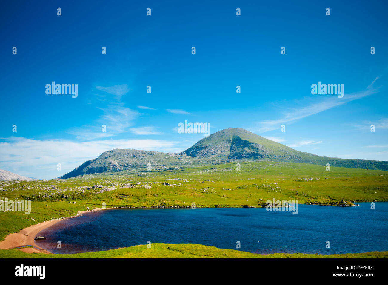 Scottish loch with sandy beach, mountains and blue sky Stock Photo - Alamy