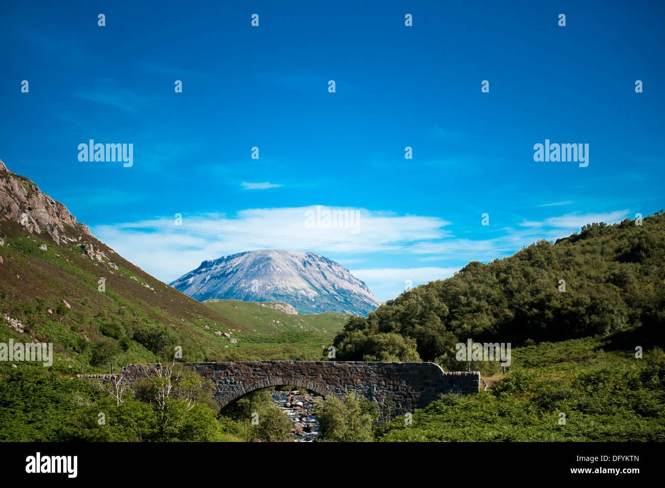 Mountain above stone arch bridge Stock Photo - Alamy