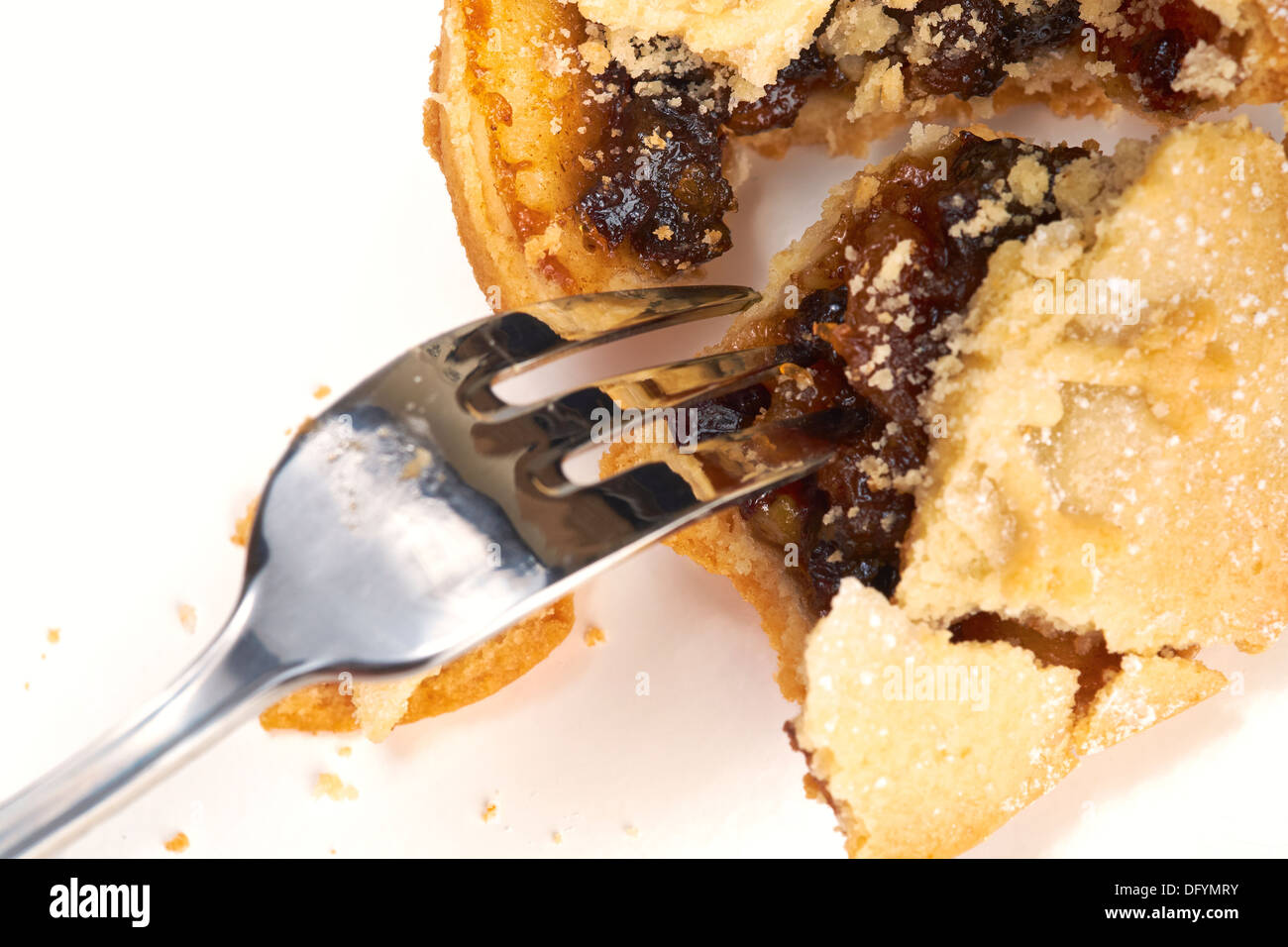 A broken sweet Christmas mince pie on a white background Stock Photo ...