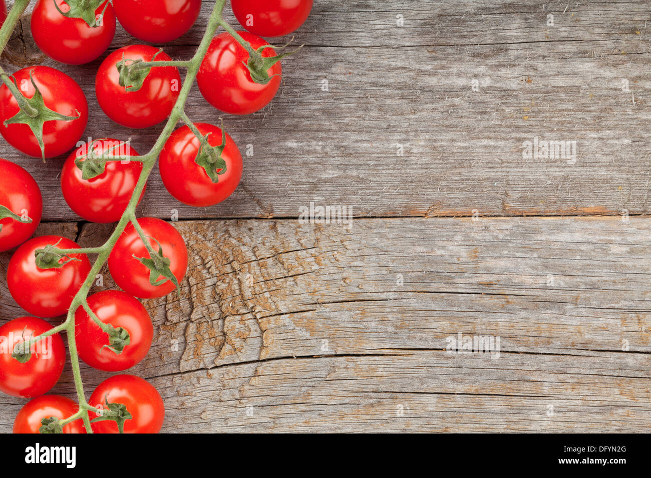 Wood table with cherry tomatoes and copyspace Stock Photo - Alamy