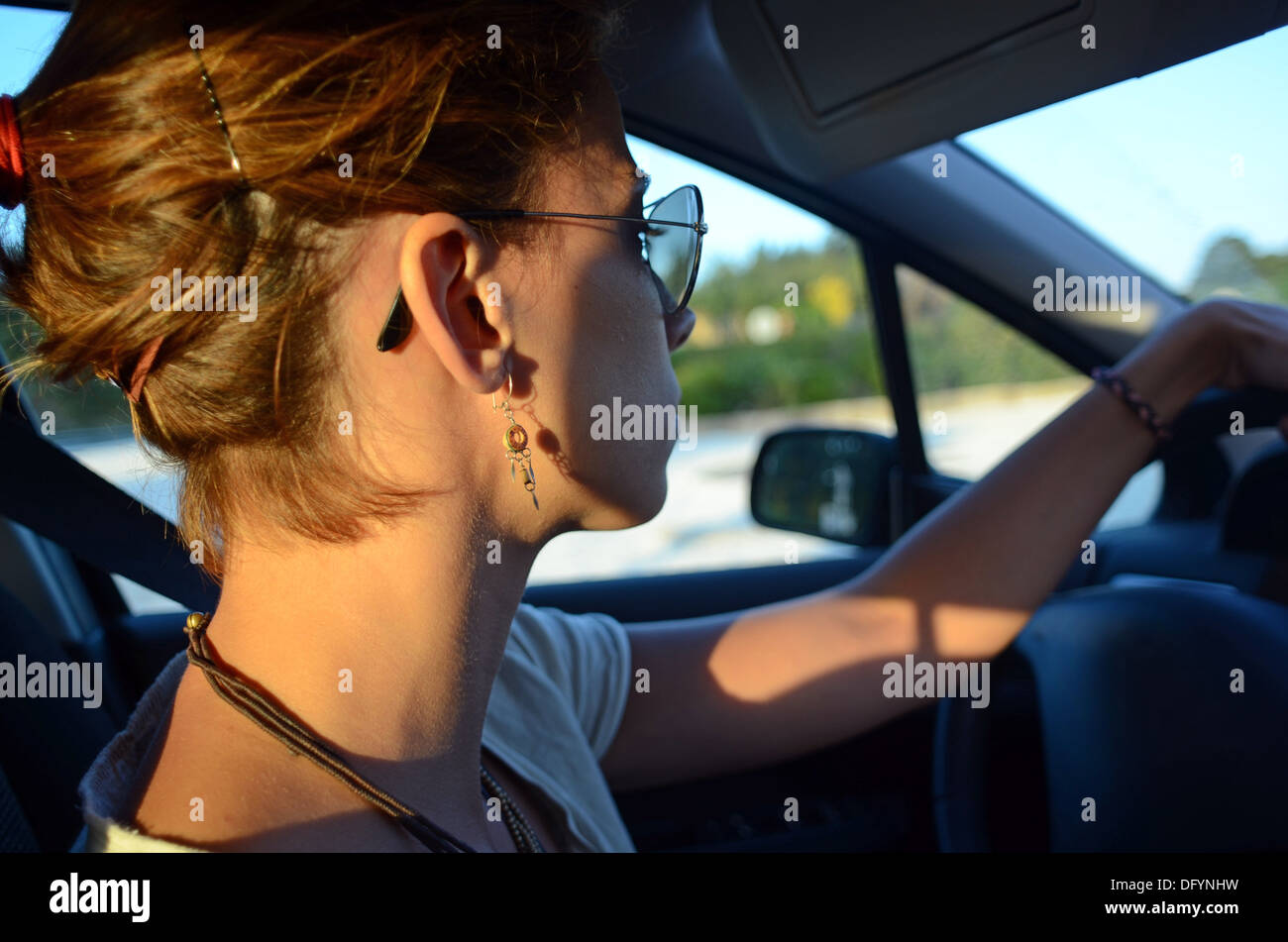 Young woman driving car sunset hi-res stock photography and images - Alamy