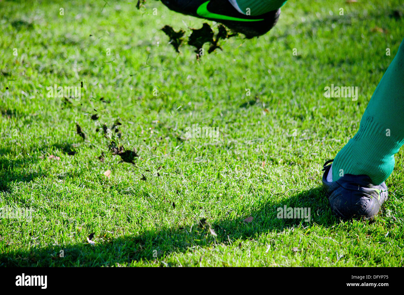 Falling turf after kick Stock Photo - Alamy