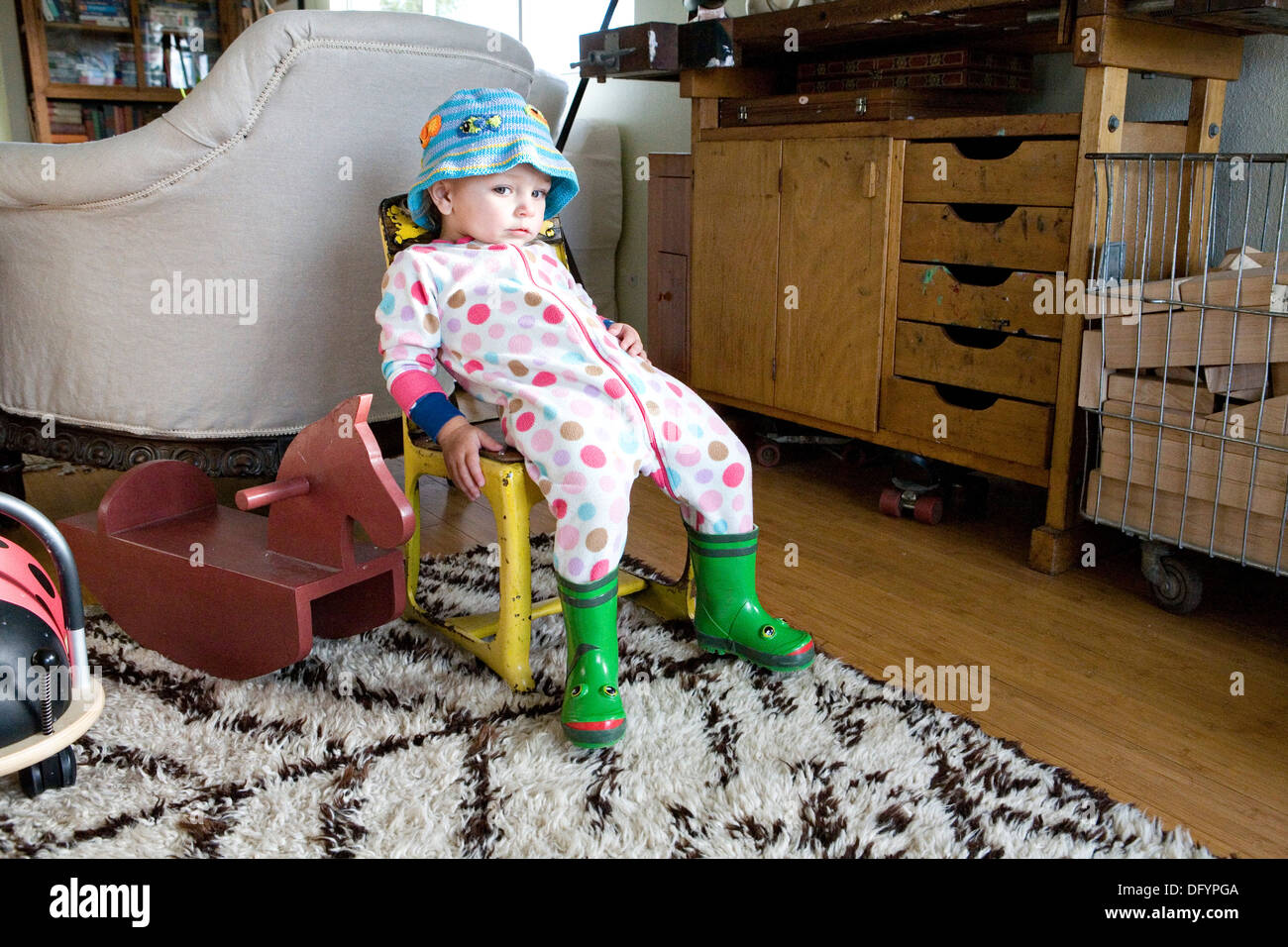 Cute Toddler Girl Sitting Stock Photo - Alamy