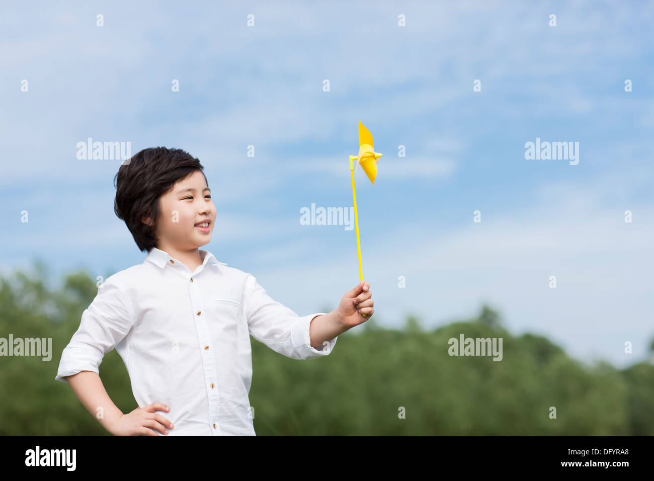 Happy boy playing paper windmill in the open air Stock Photo - Alamy