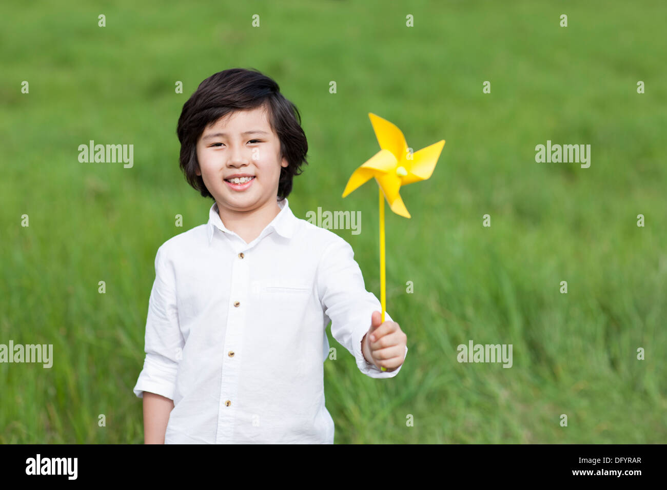 Happy boy playing paper windmill in the open air Stock Photo - Alamy