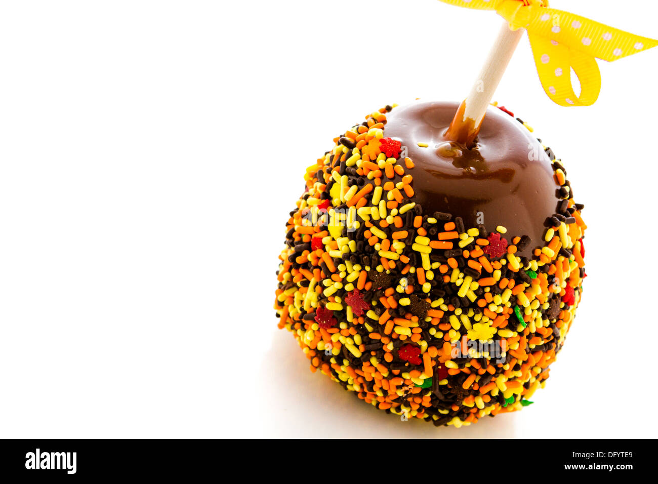 Hand dipped caramel apple covered with multi color sprinkles Stock ...