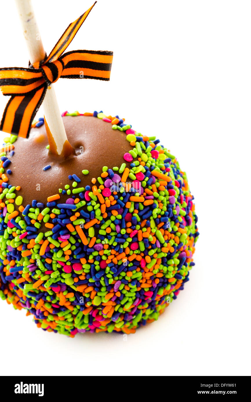 Hand dipped caramel apple covered with multi color sprinkles Stock ...