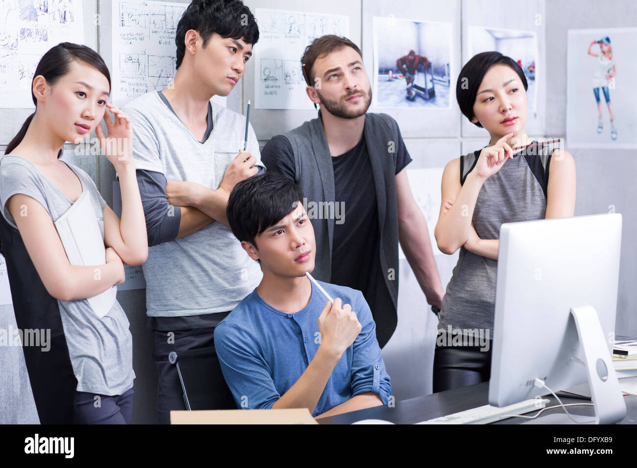 Young adults thinking in office Stock Photo - Alamy