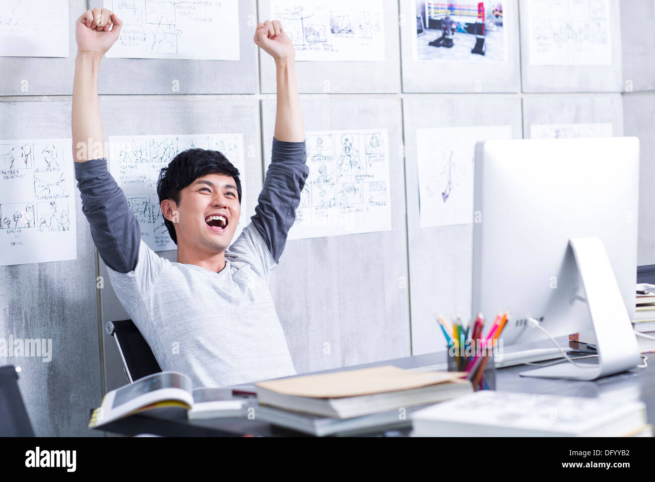 Asian man celebrating desk hi-res stock photography and images - Alamy