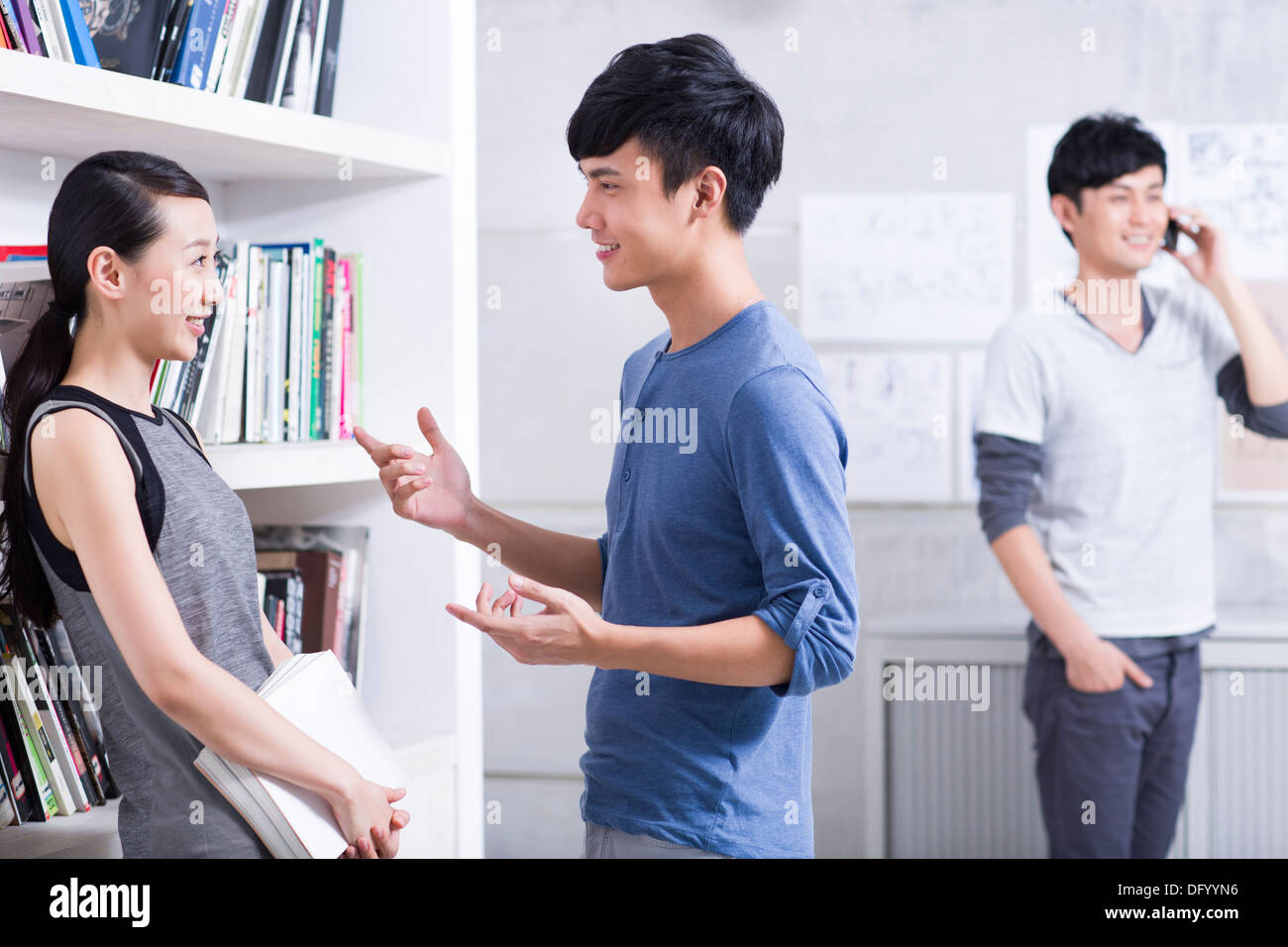 Young office workers in communication Stock Photo - Alamy