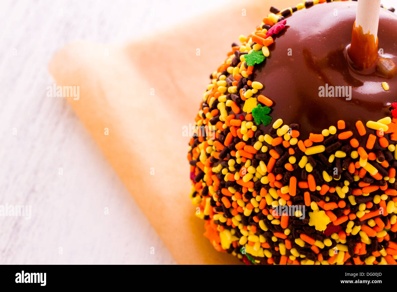 Hand dipped caramel apple covered with multi color sprinkles Stock ...