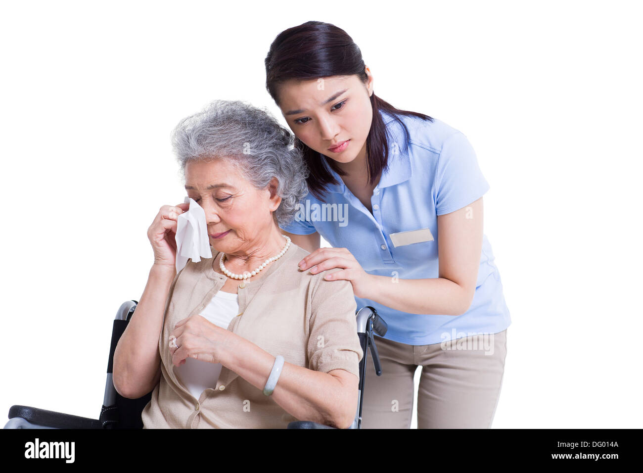 Female nursing worker comforting weeping senior woman Stock Photo - Alamy