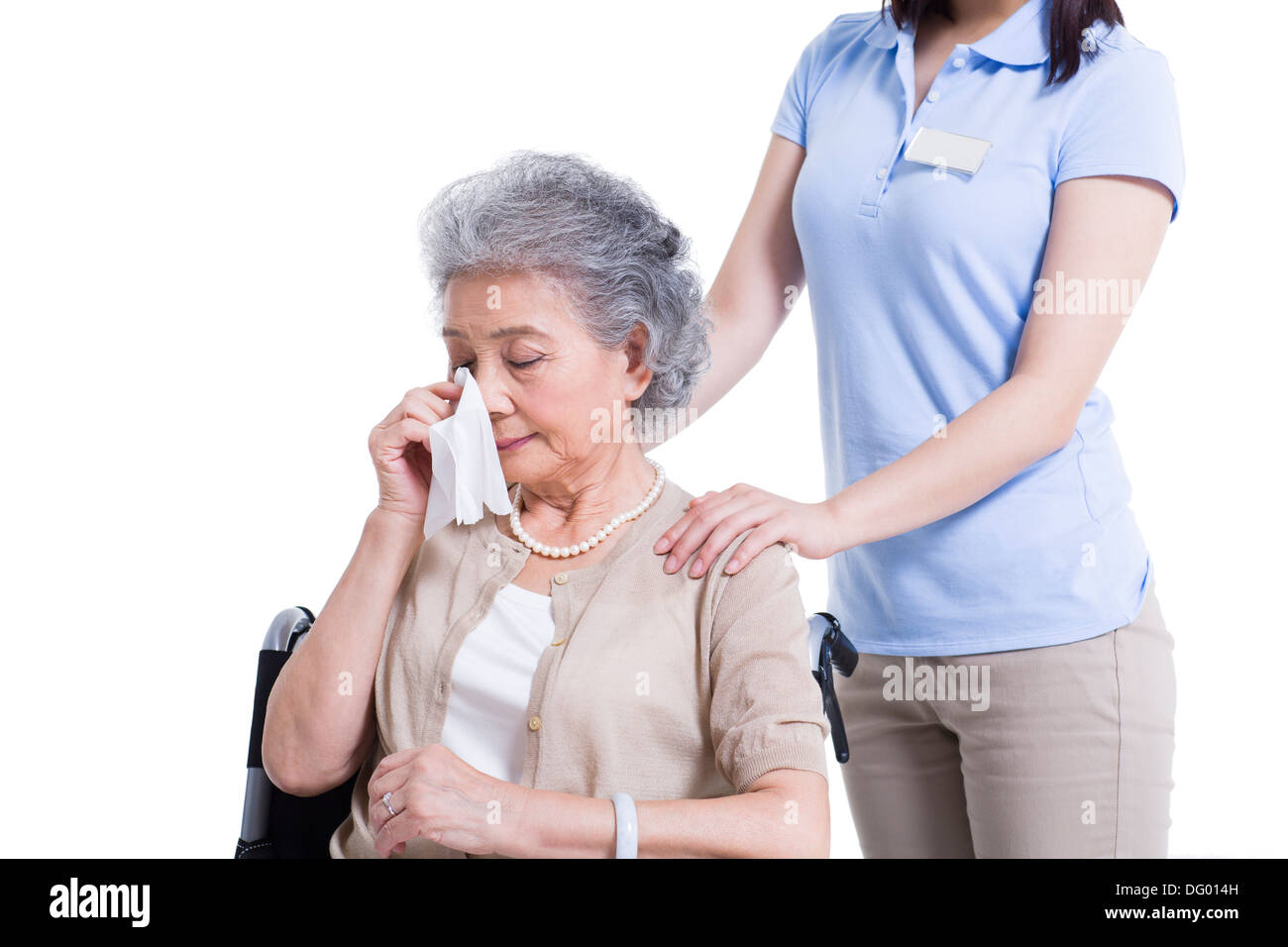 Female nursing worker comforting weeping senior woman Stock Photo - Alamy