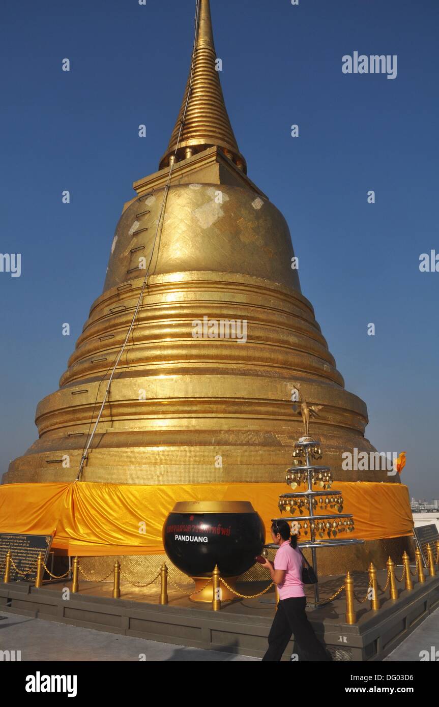 Bangkok (Thailand): a woman praying at the pagoda on the top of the ...