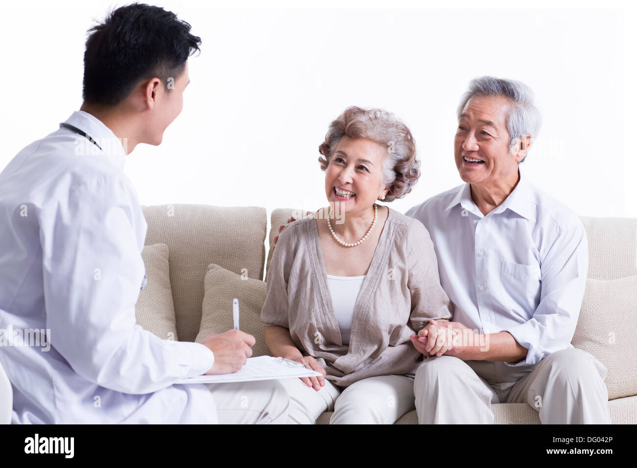 Doctor talking with senior couple Stock Photo - Alamy