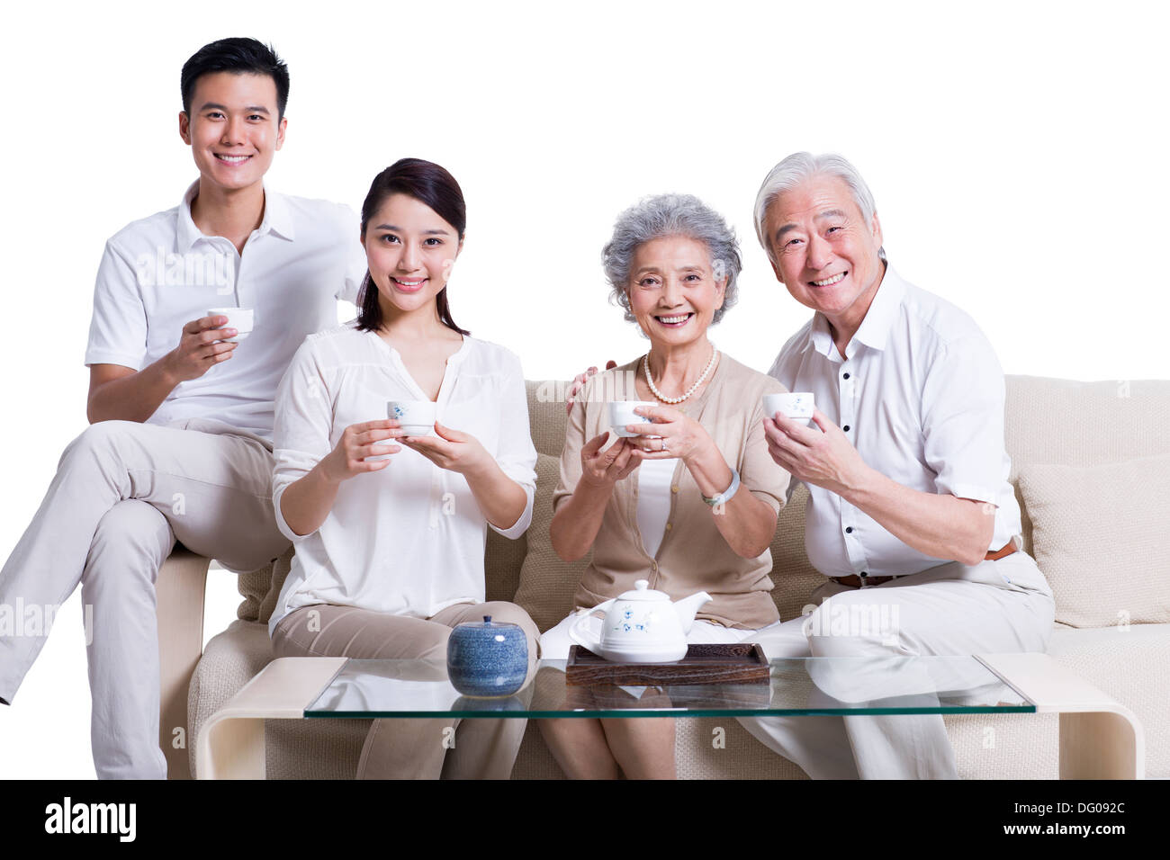 Cheerful family having tea Stock Photo - Alamy