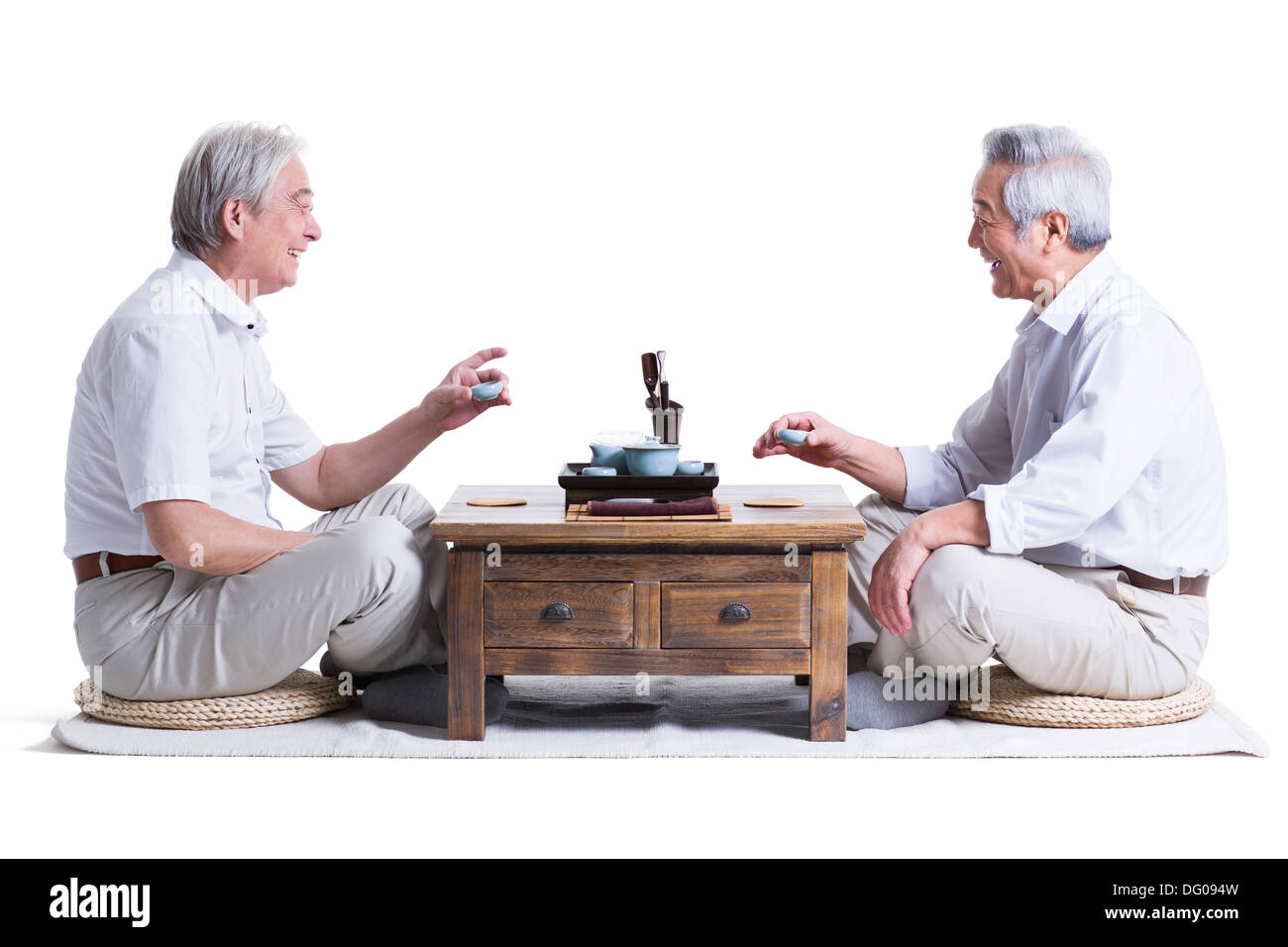 Male senior friends chatting over tea Stock Photo - Alamy