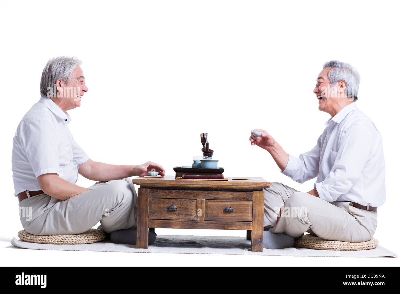 Male senior friends chatting over tea Stock Photo - Alamy