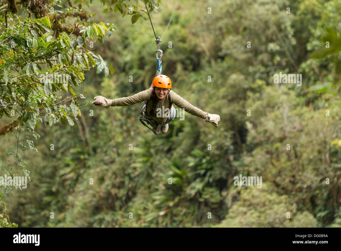 Happy Adult Woman On Zip Line Above Dense Vegetation In South America ...