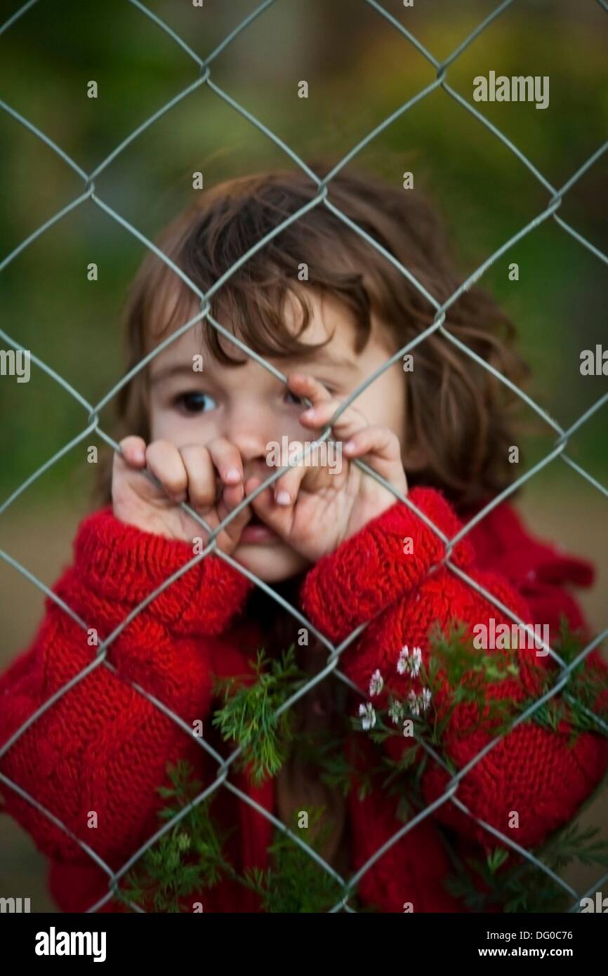 Young girl behind fence Stock Photo - Alamy