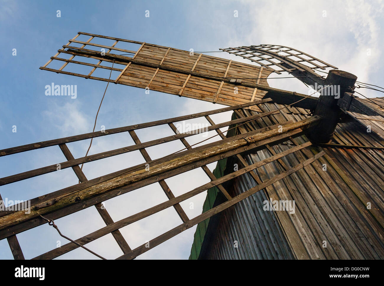 Old wooden traditional ukrainian windmill over blue sky with clouds ...