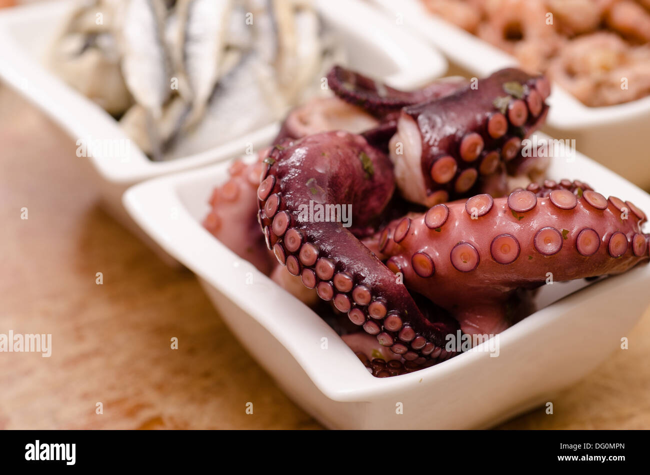 Octopus with suckers as appetizer in a white bowl Stock Photo - Alamy
