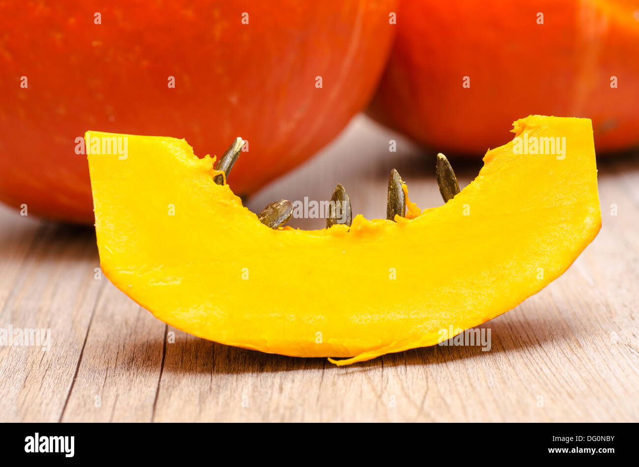 Orange slice of a pumpkin with seeds Stock Photo - Alamy