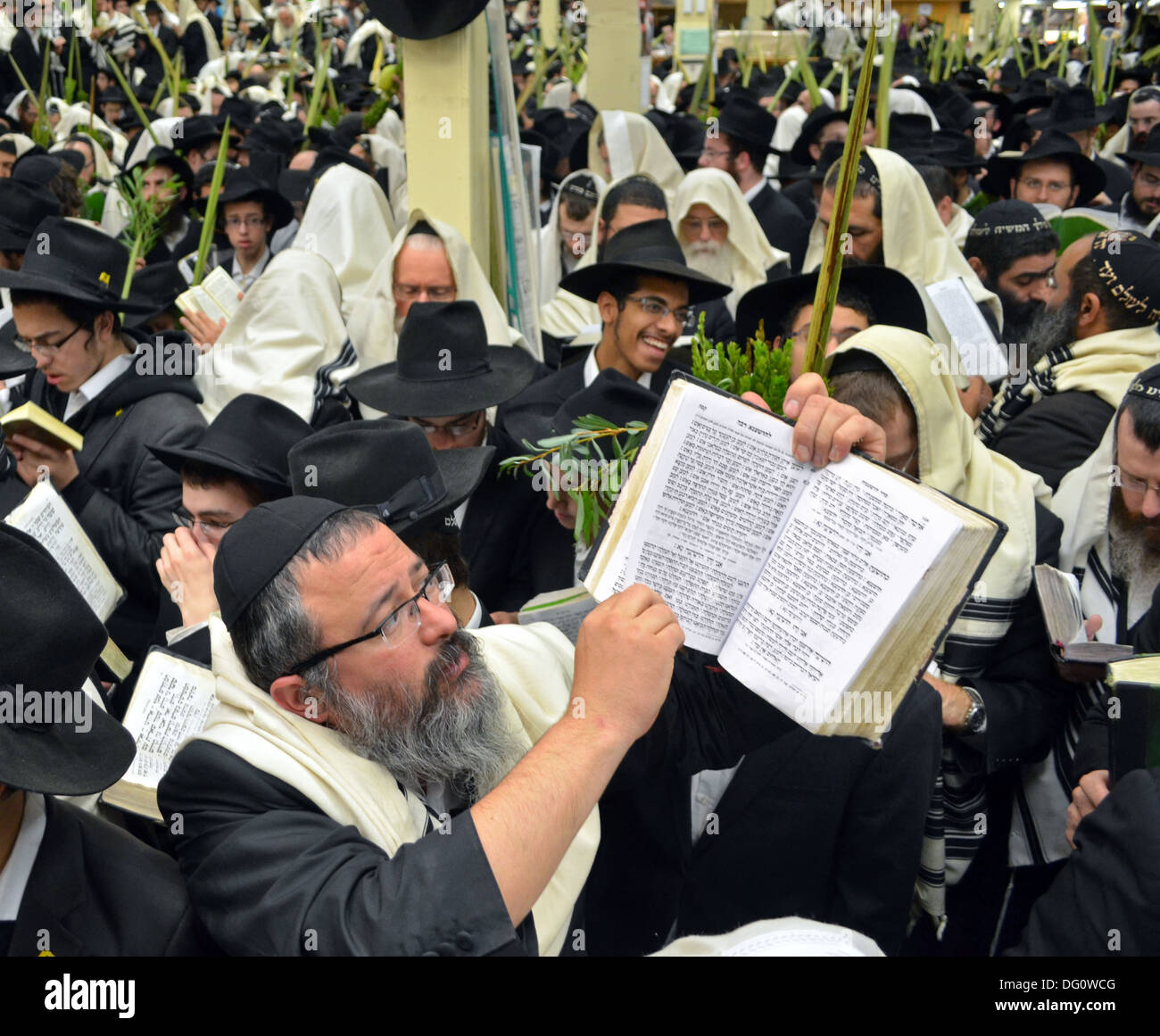 Religious Jewish man in a crowd pointing something out to his son ...