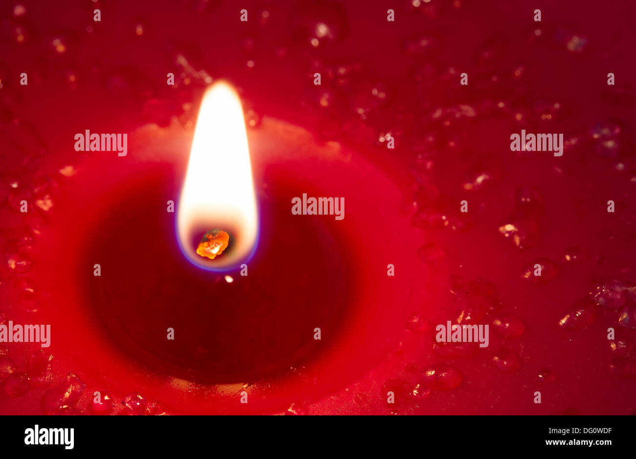 Close up glowing red candle Stock Photo - Alamy