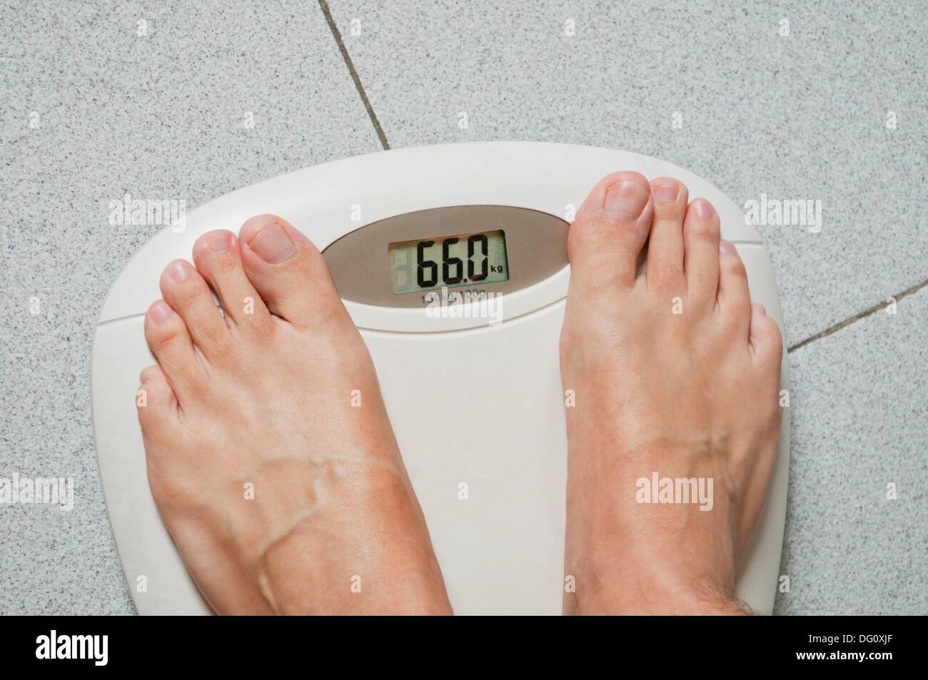 Man weighing himself hi-res stock photography and images - Alamy