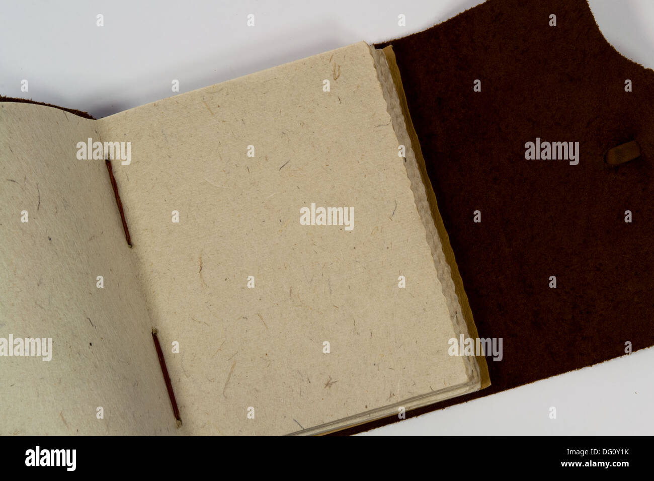 Open leather bound journal with natural fiber paper pages isolated on a ...