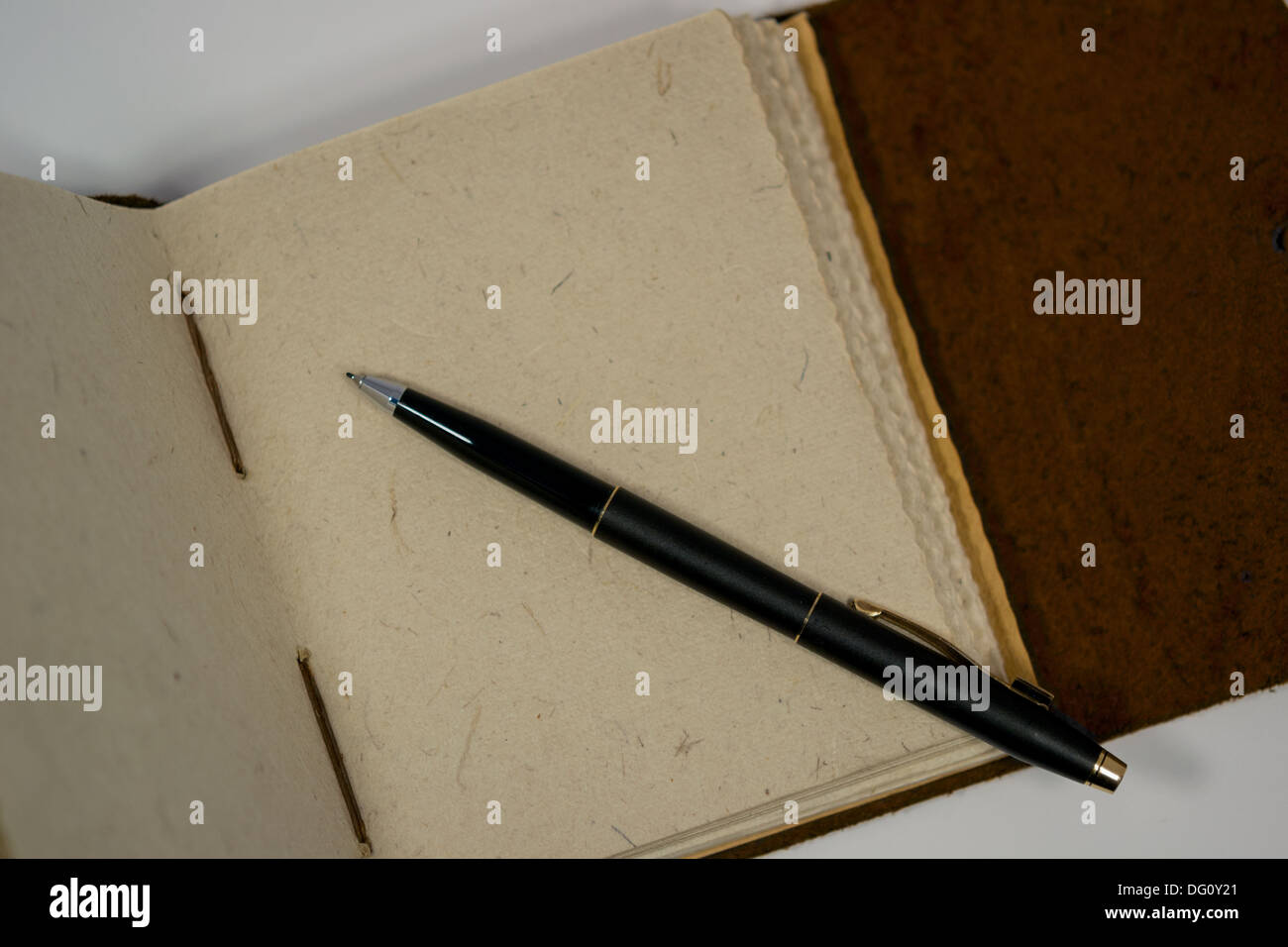 Open leather bound journal with natural fiber paper pages and pen Stock ...