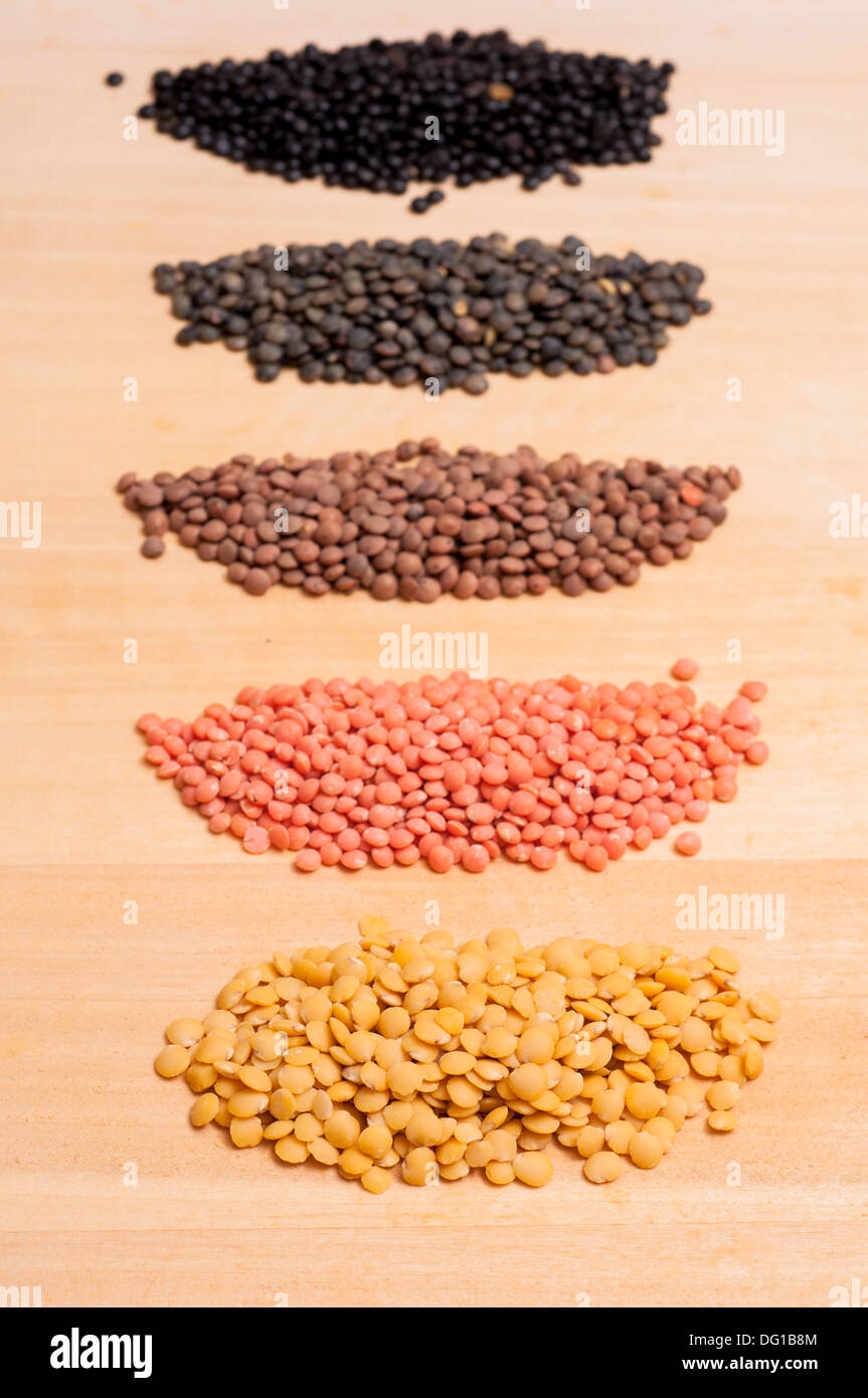 Five different lentis on a wooden board Stock Photo - Alamy