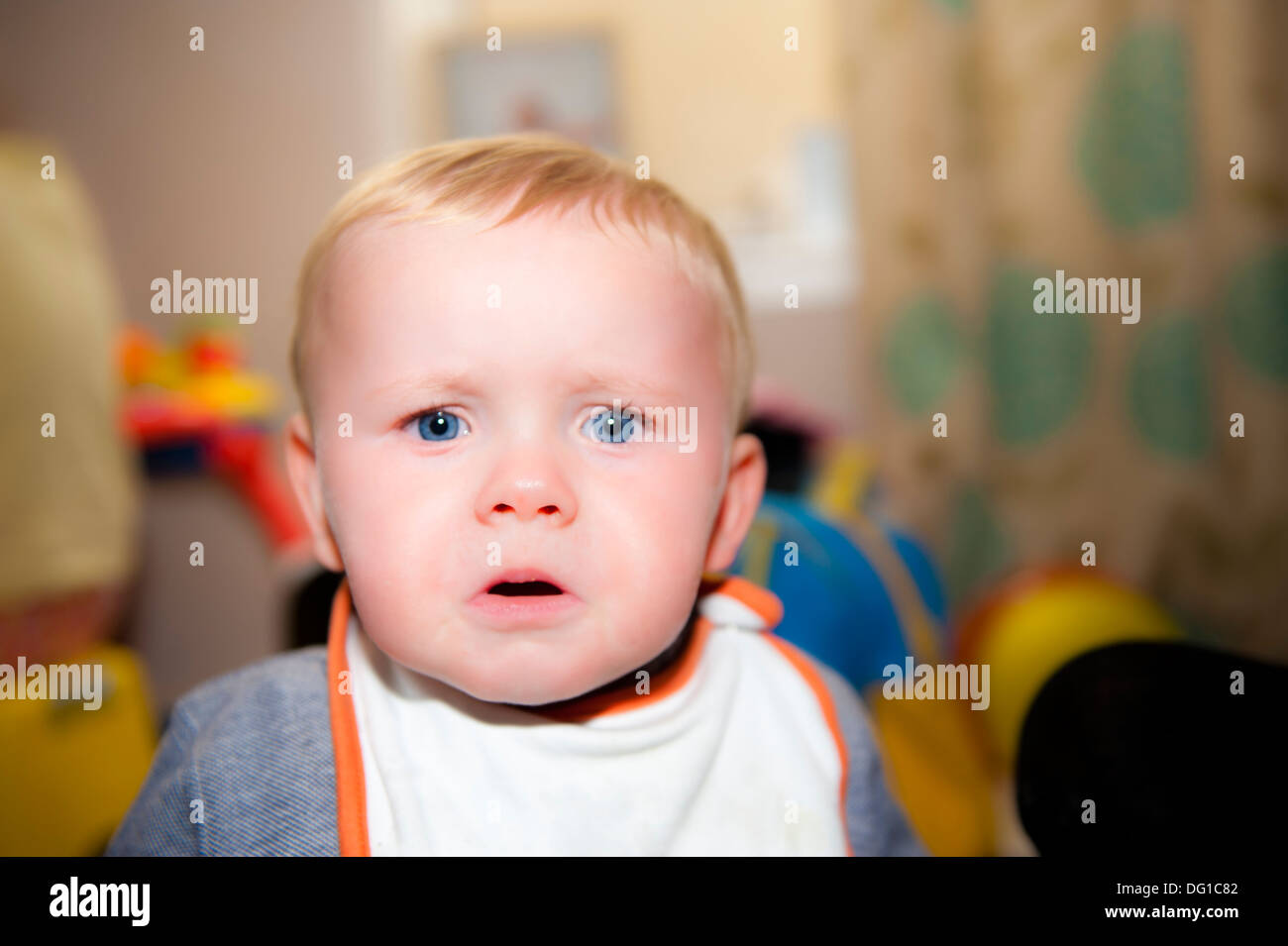 baby boy looking at camera with sad expression Stock Photo - Alamy