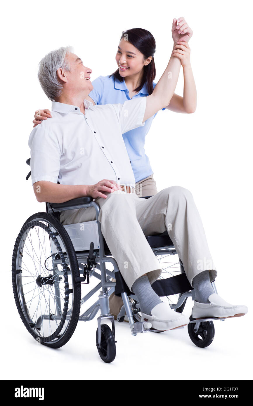 Female nursing worker helping senior man doing exercise Stock Photo - Alamy
