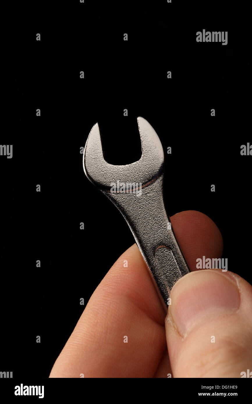 Metallic wrench in male hand Stock Photo - Alamy