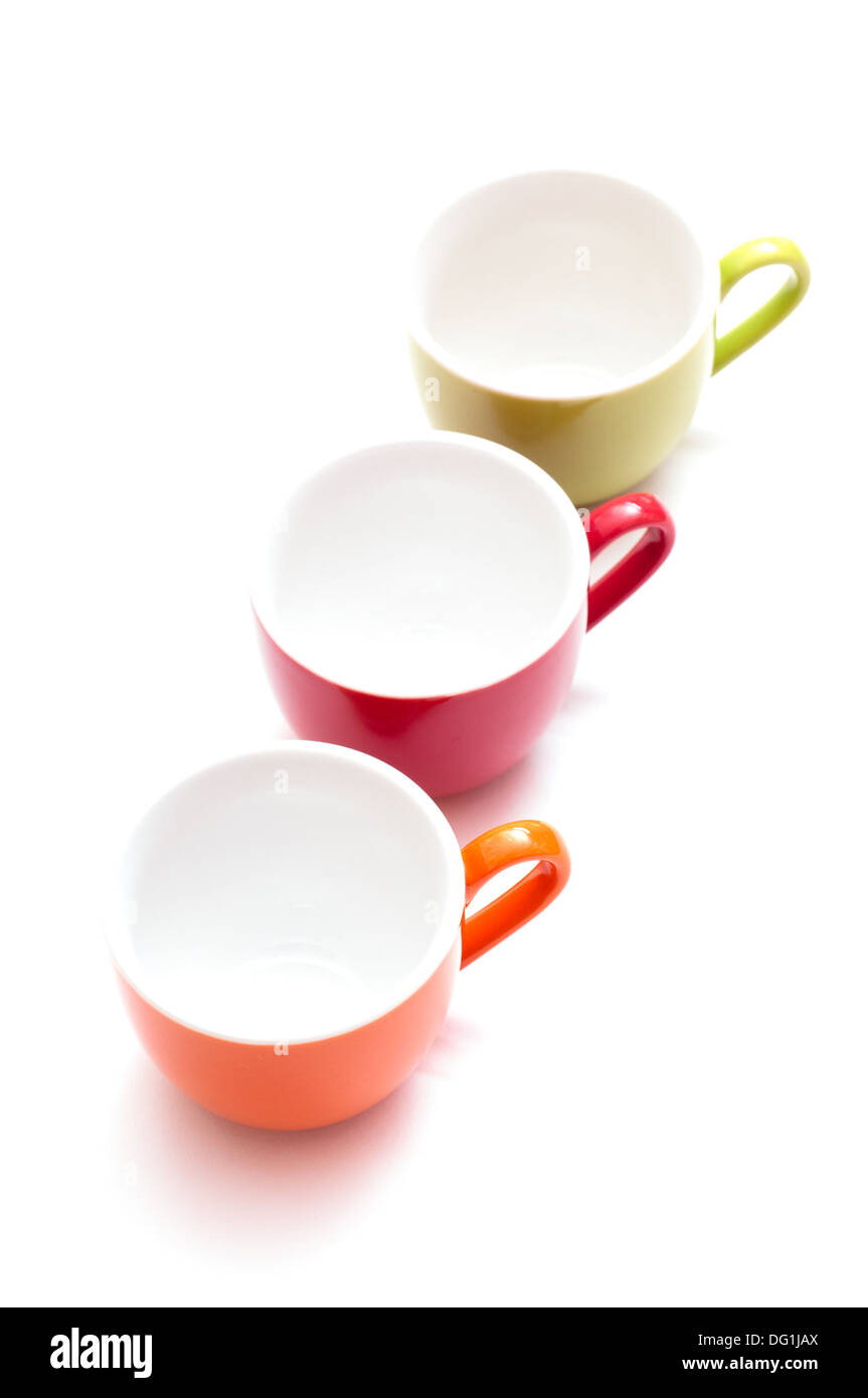 Three coloured coffee mugs on a white background Stock Photo - Alamy