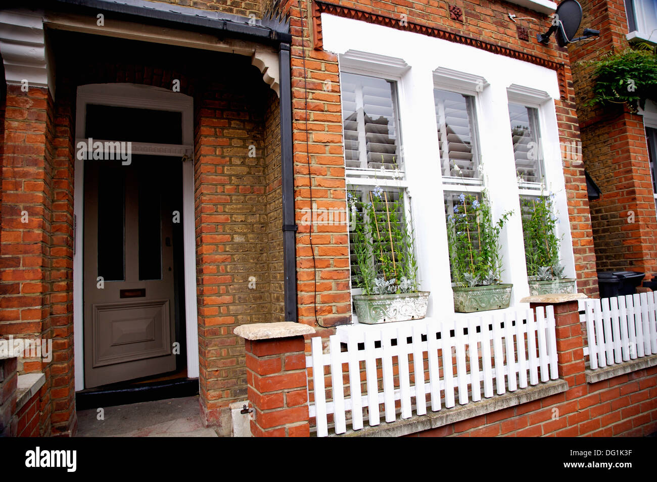 White picket fence in front of window of Edwardian townhouse Stock ...