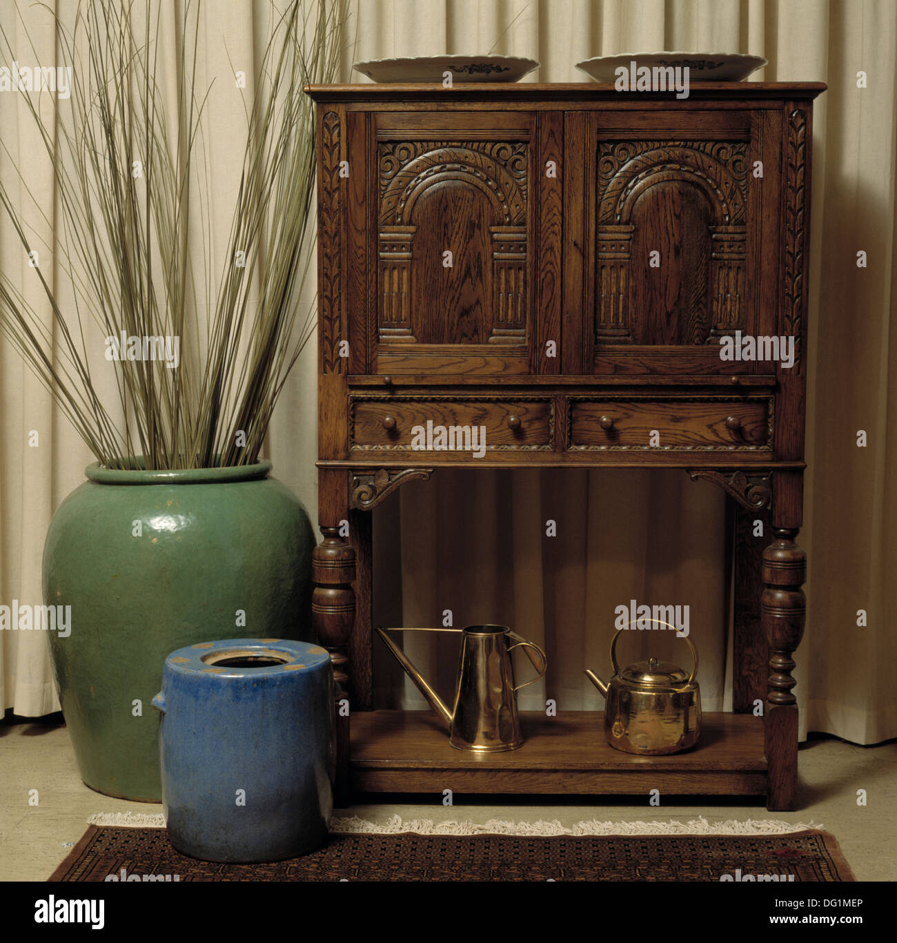 Blue circular ceramic pot and large green ceramic pot with grasses ...