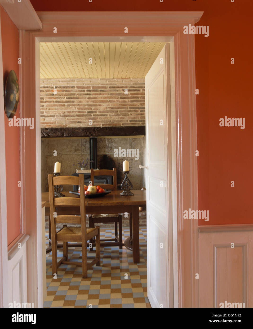 View through doorway of pink hall to blue and brown tiled floor in ...