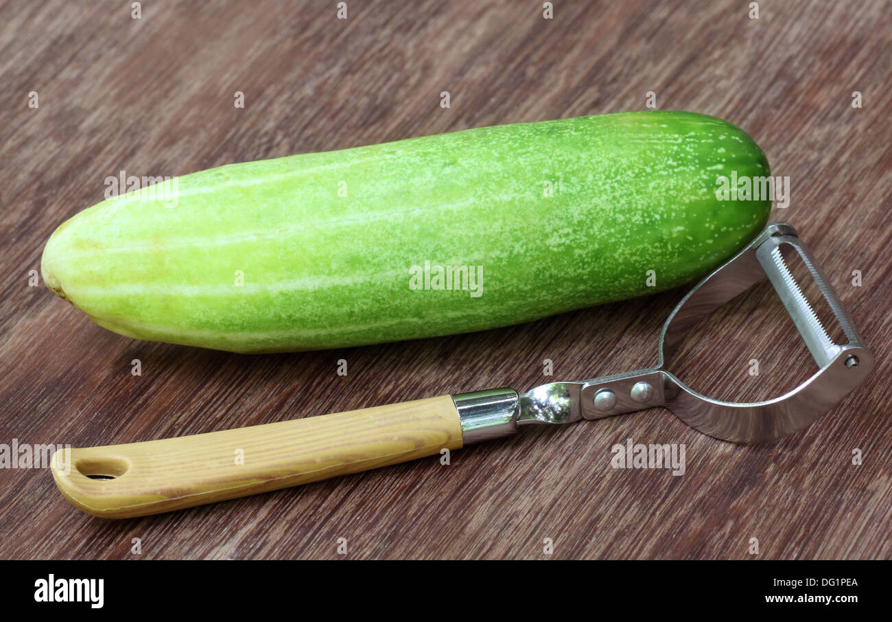 Fresh cucumber with peeler Stock Photo - Alamy