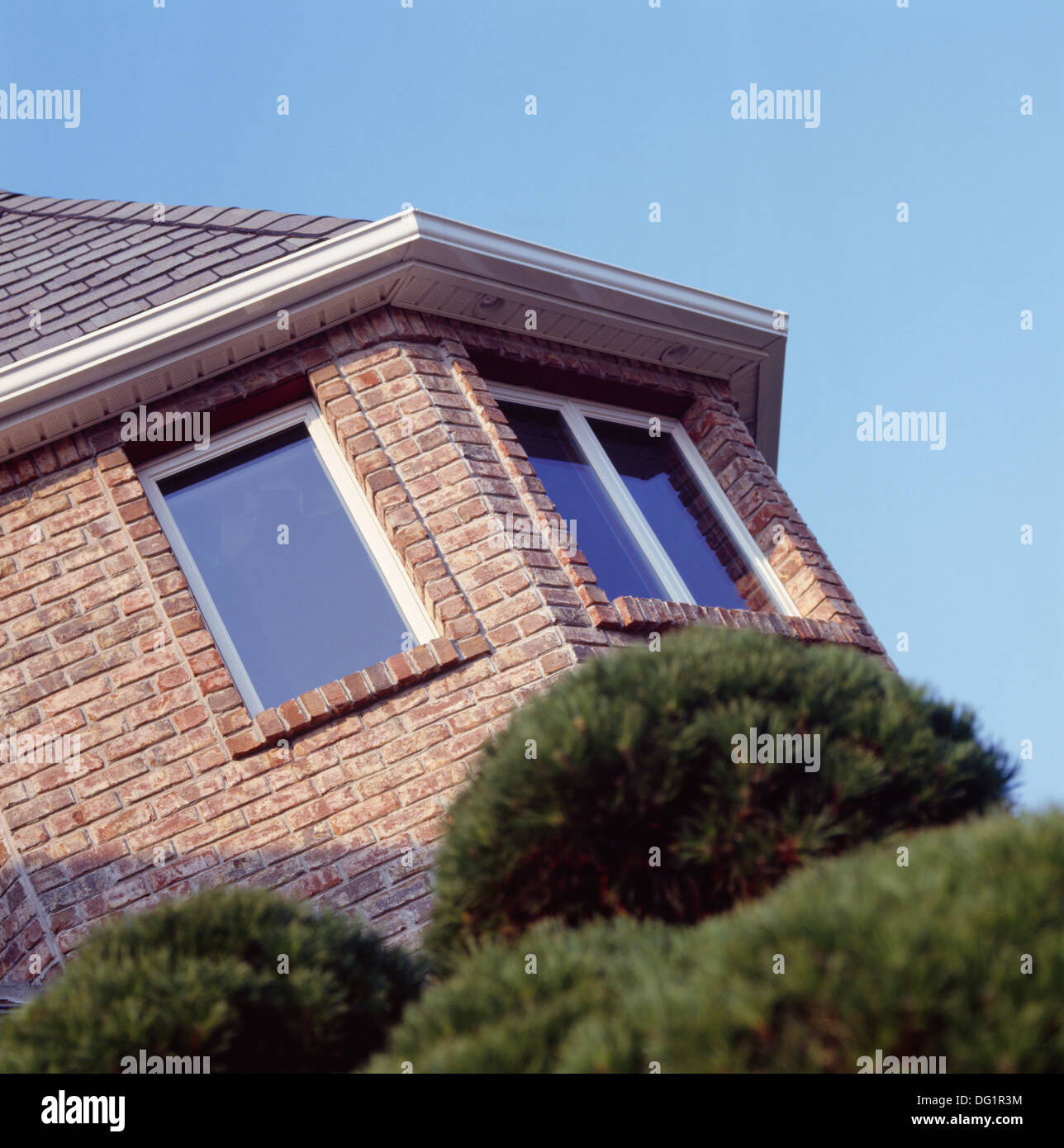 Looking up at windows in newly built brick house Stock Photo - Alamy