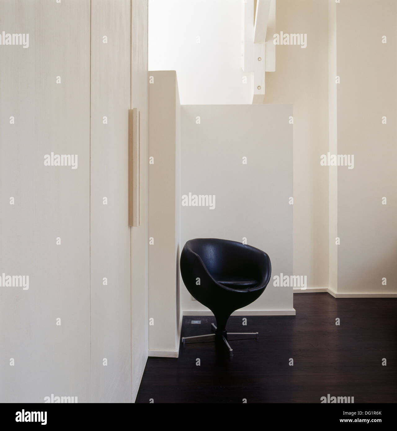 Black leather swivel chair in modern white hall with black flooring ...