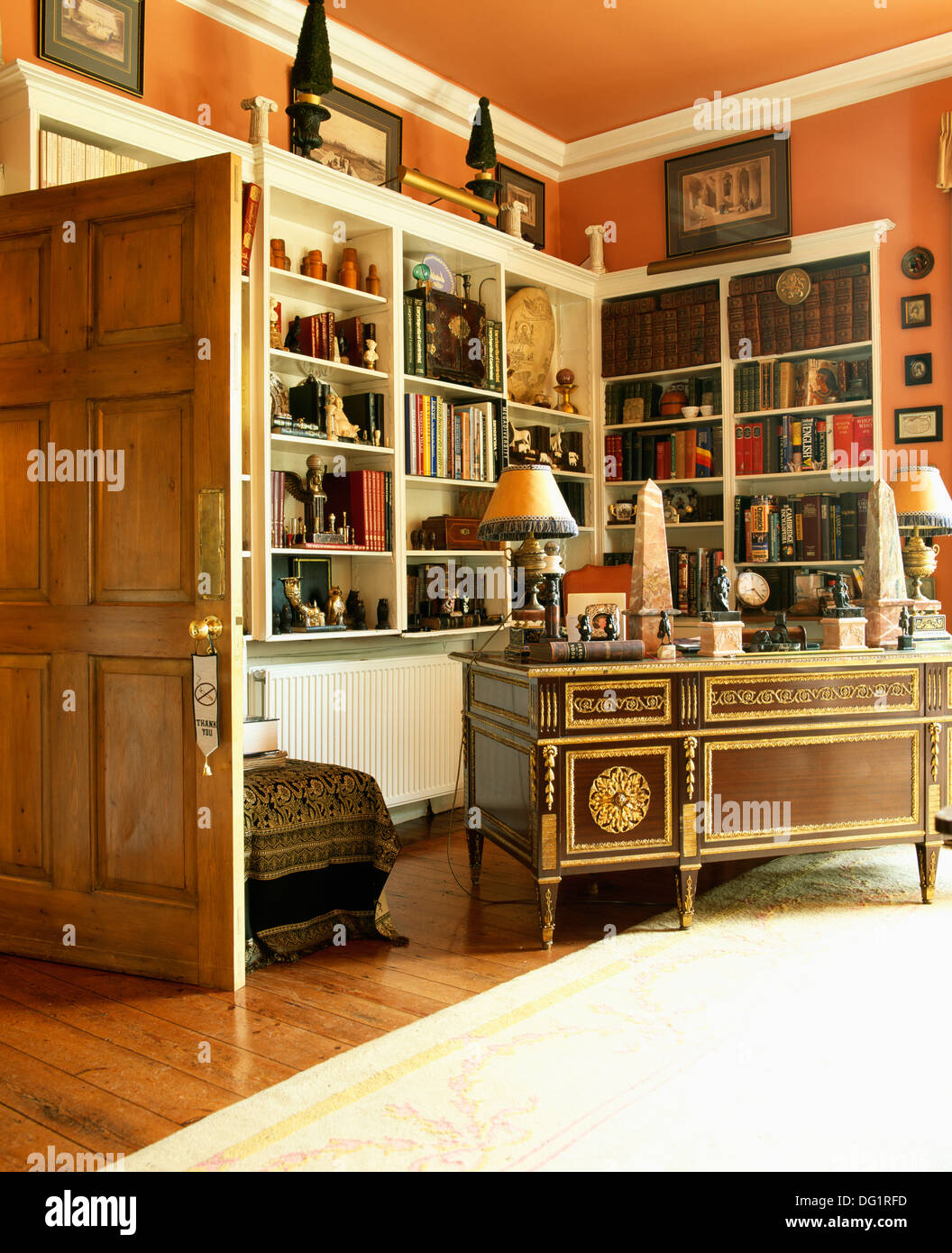 Antique desk in front of bookcases in country house study Stock Photo ...