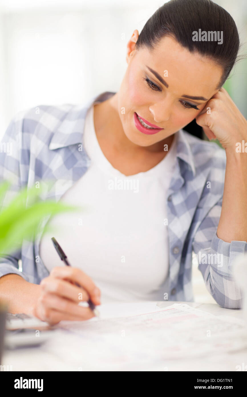 pretty young woman filling her tax forms Stock Photo - Alamy